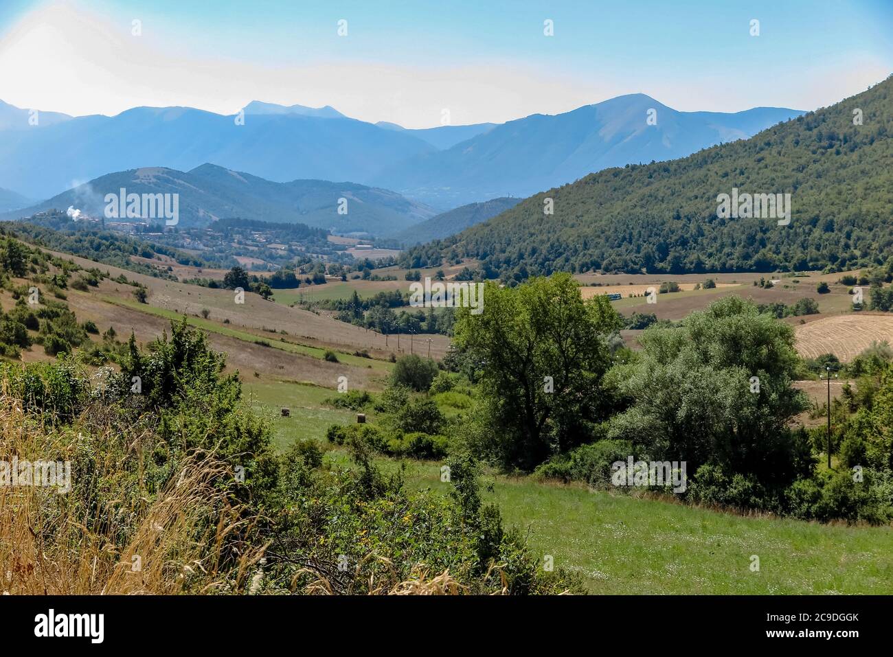 Large valley with farms, plantations, forest and mountains in the ...