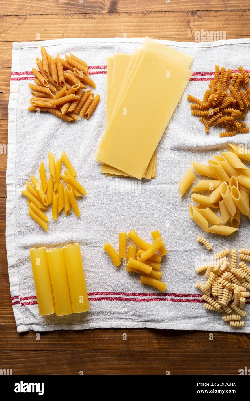 Uncookes Italian pasta types on white linen cloth top view Stock Photo ...