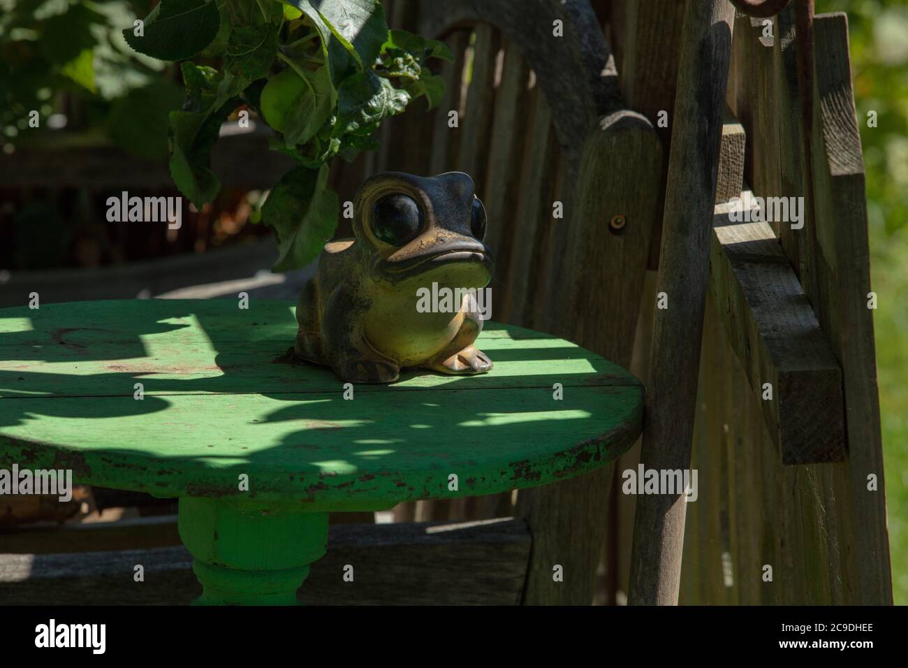 A small wooden frog object used as decoration in a corner of the ...