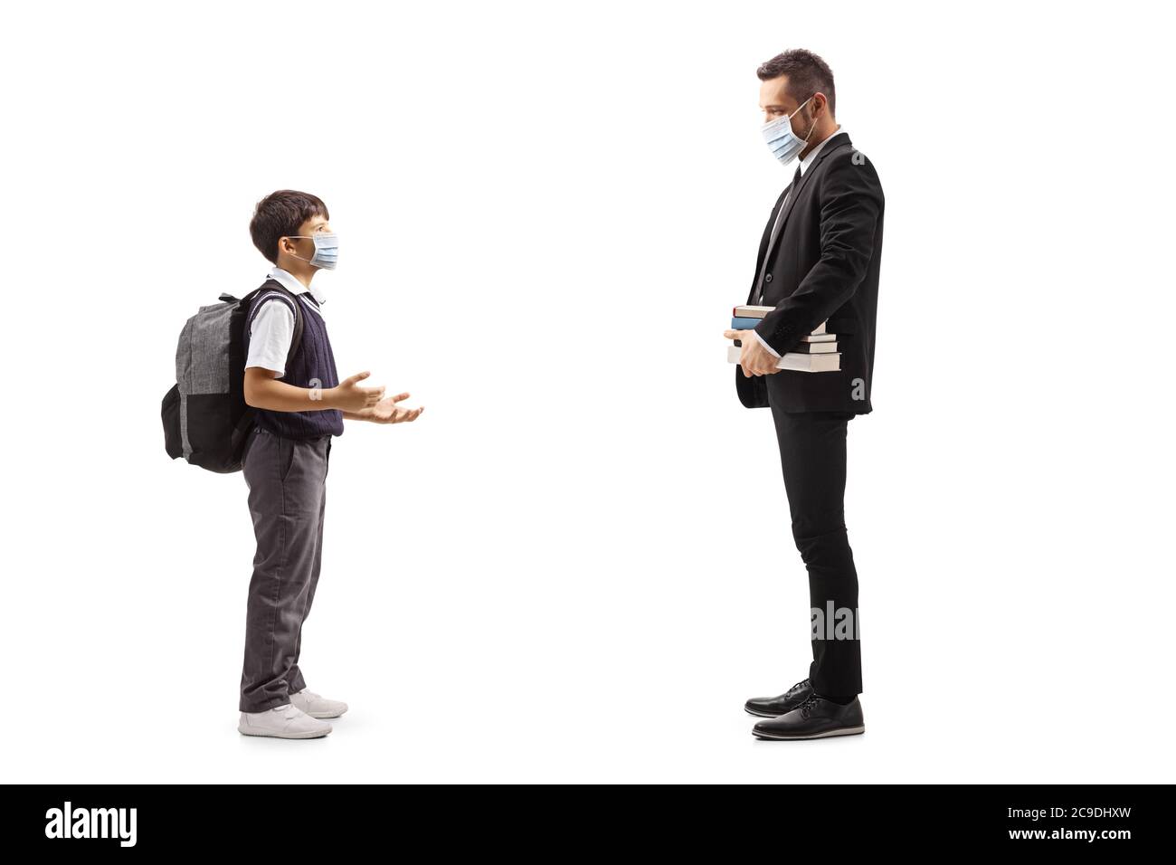 Full length profile shot of a schoolboy and a male teacher with ...