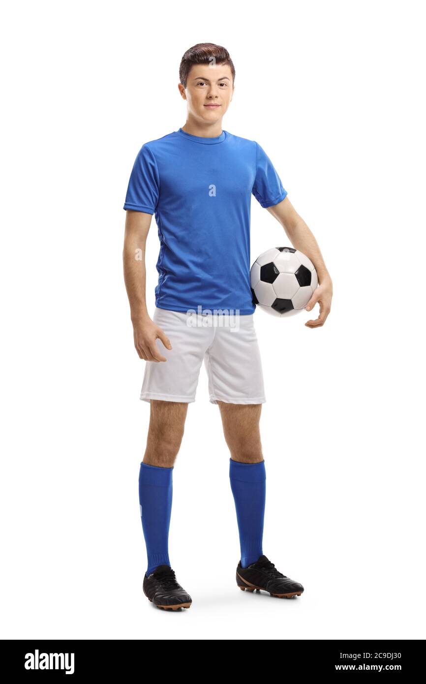 Full length portrait of a teenager soccer player with a ball under arm ...