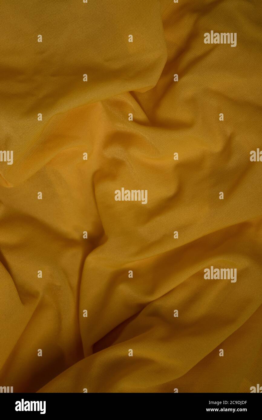 yellow fabric, silk background. suitable for design paper, banners ...