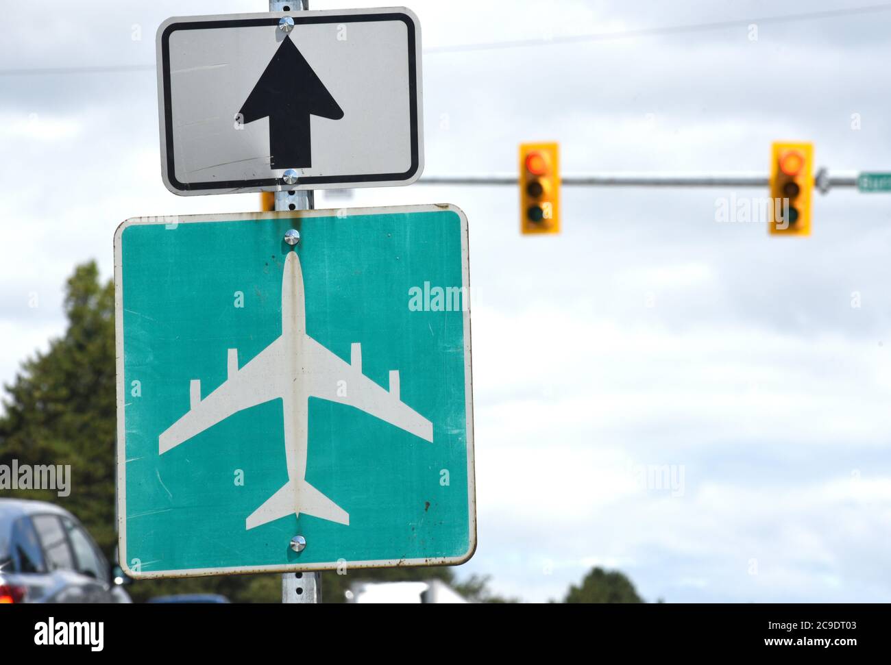 Signs featuring an aircraft symbol and an arrow direct drivers to an ...