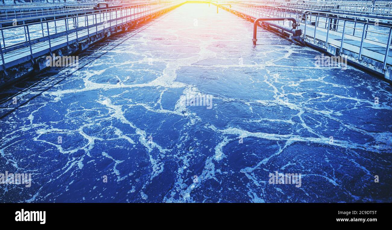 Water treatment tank with wastewater, aeration process in blue color ...