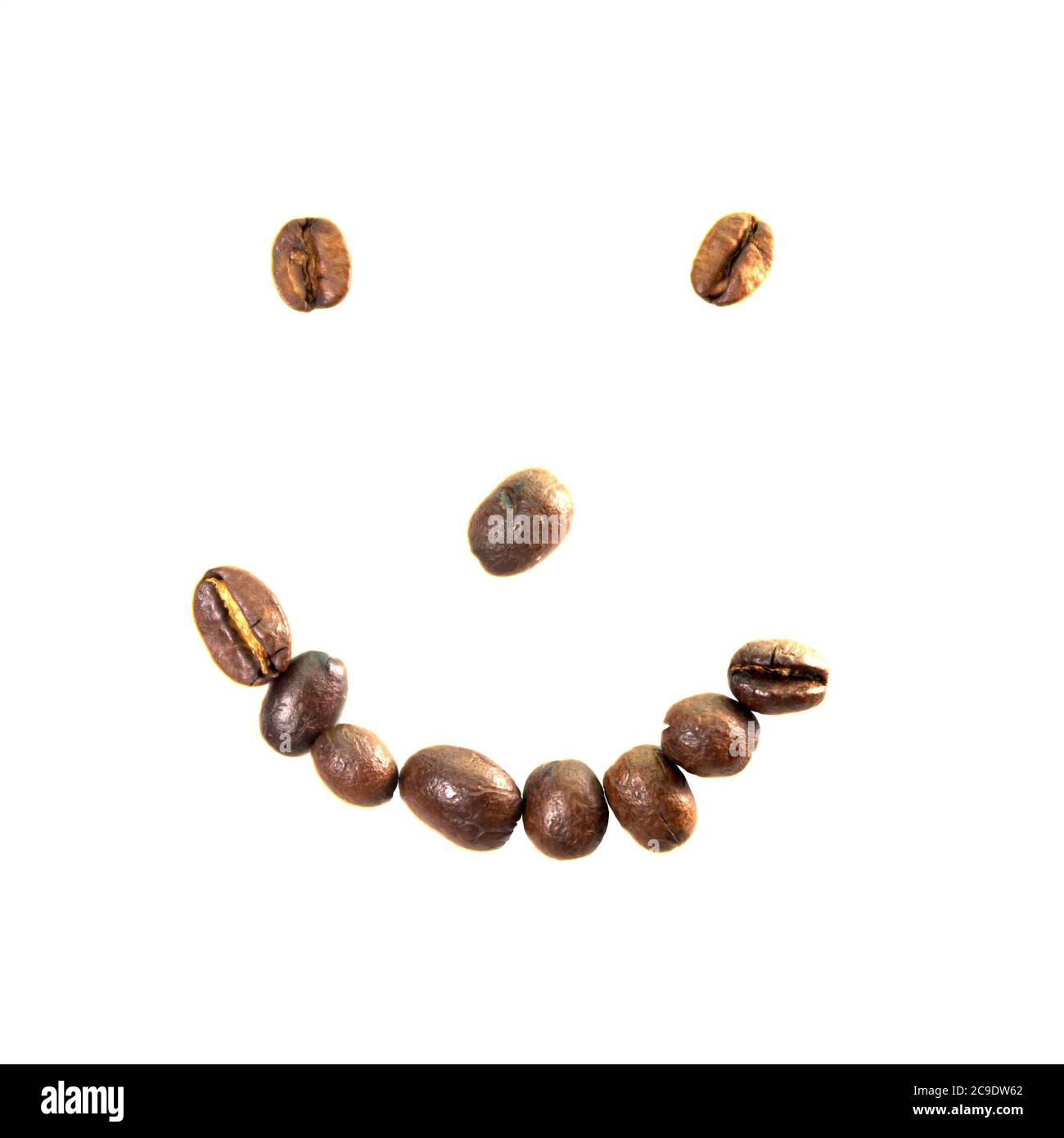 Close-up of roasted coffee beans in the shape of a smiley face ...