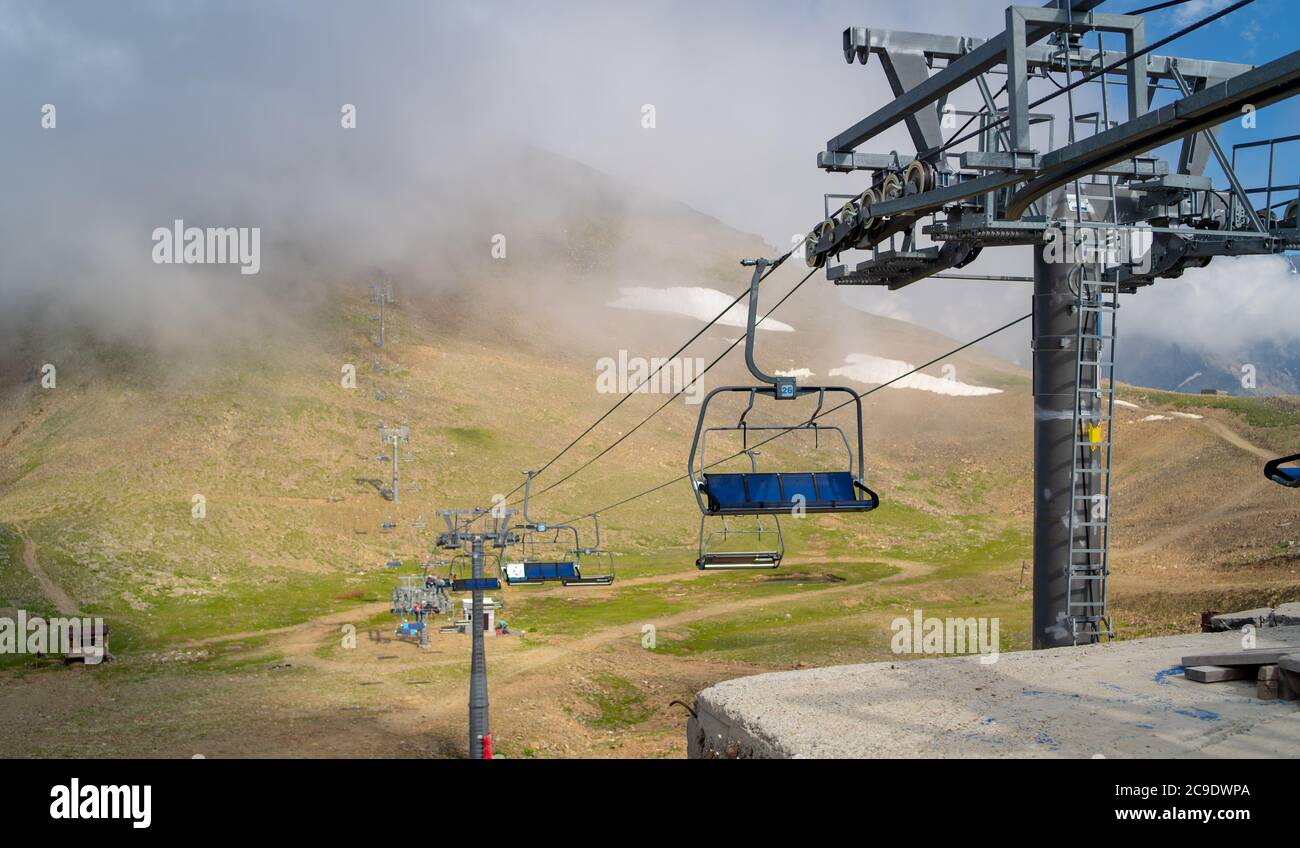 Close up of cableway in clouds. Clouds enveloping modern ropeway with ...