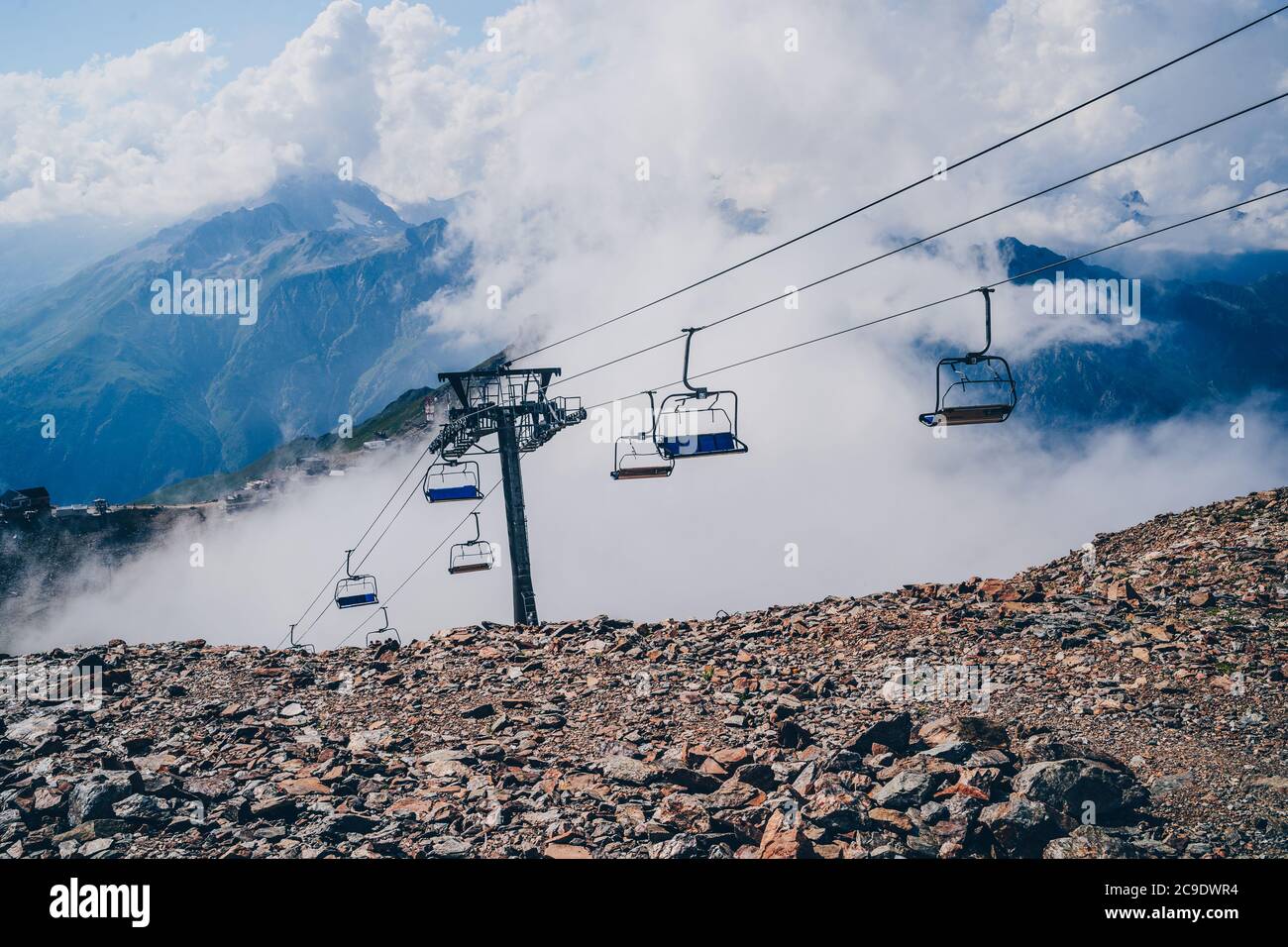 Close up of cableway in clouds. Clouds enveloping modern ropeway with ...