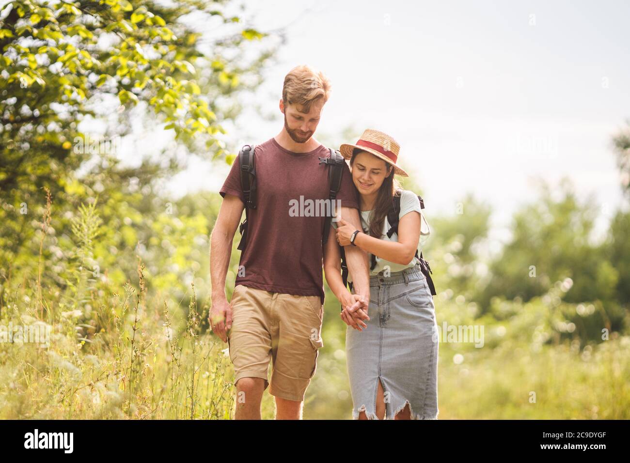 Couple Hiking Along Woodland Path. Happy loving man and woman on ...