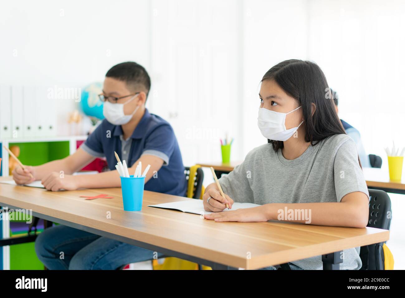 Group of Asian elementary school students wearing hygienic mask to ...