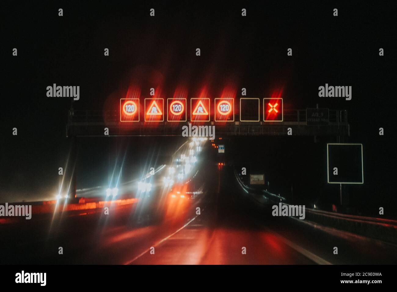 reflections of street signs and cars at night Stock Photo - Alamy