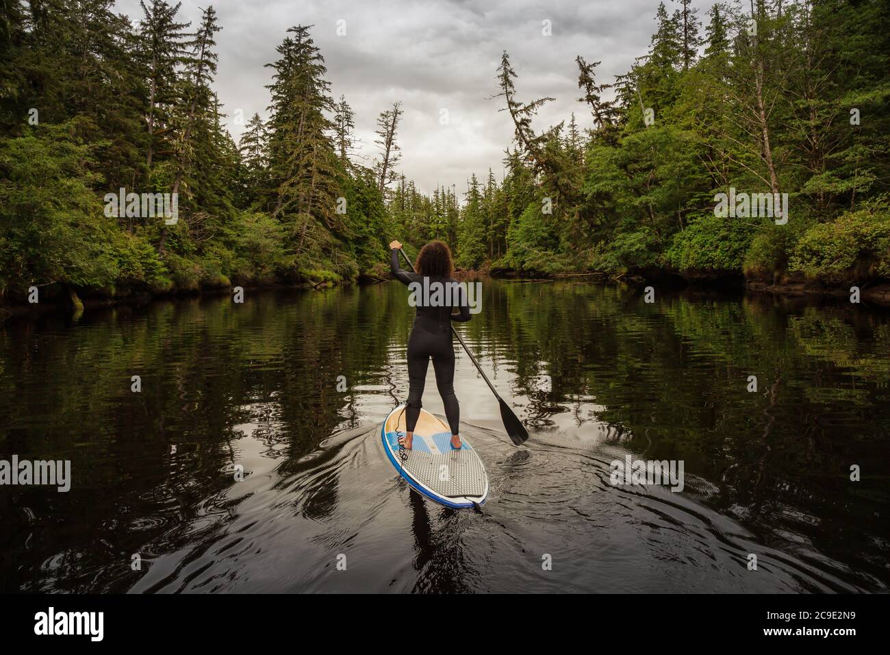 Girl Paddle Boarding in a River near the Pacific Ocean Stock Photo - Alamy