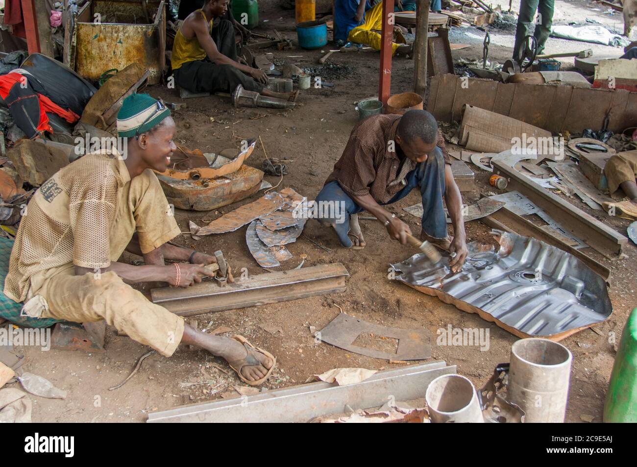 A worker is reusing scrap metal in Bamako, the capital and largest city ...