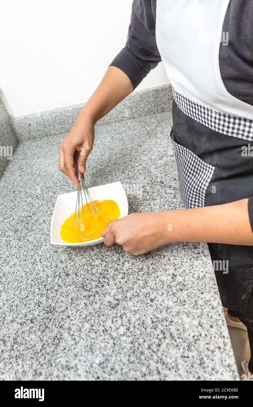 Close-up of hands beating eggs on a kitchen counter in the house Stock ...