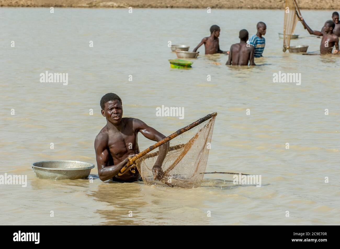 People fishing with nets in a pond near Djenne, a town in the Sahel ...