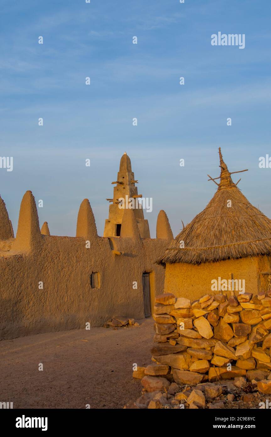 Mudbrick granaries and a mosque in evening light in the Djiguibombo ...