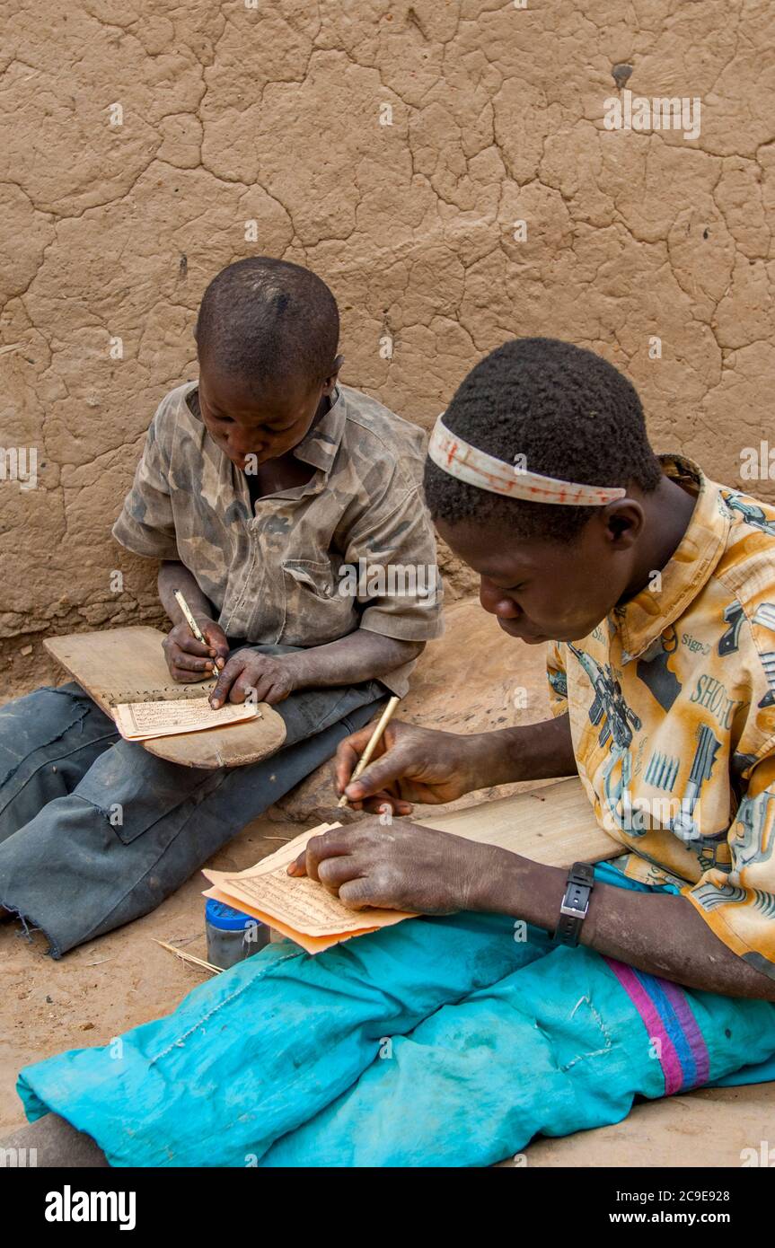 Dogon boys writing on wooden tablets in a Koran school in the Niogono ...