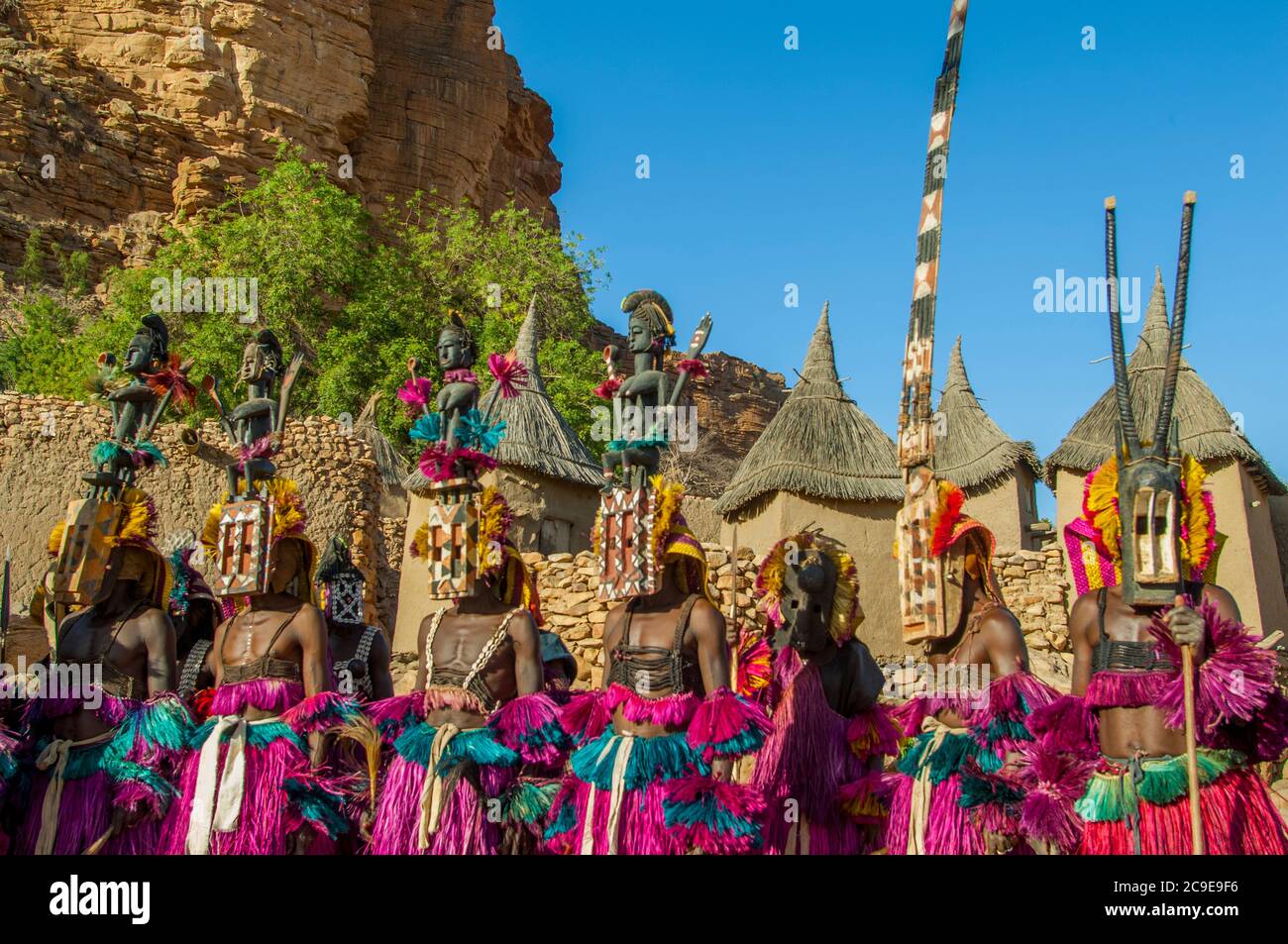 A group of Dogon dancers in traditional costumes in a Dogon village at ...