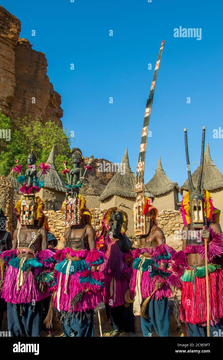 A group of Dogon dancers in traditional costumes in a Dogon village at ...