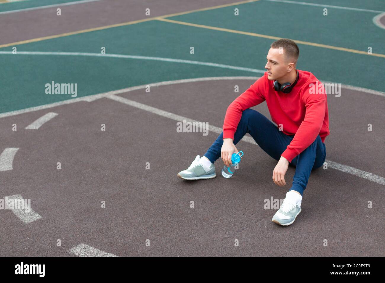 Man having rest after training on the sports ground. Sport and healthy ...