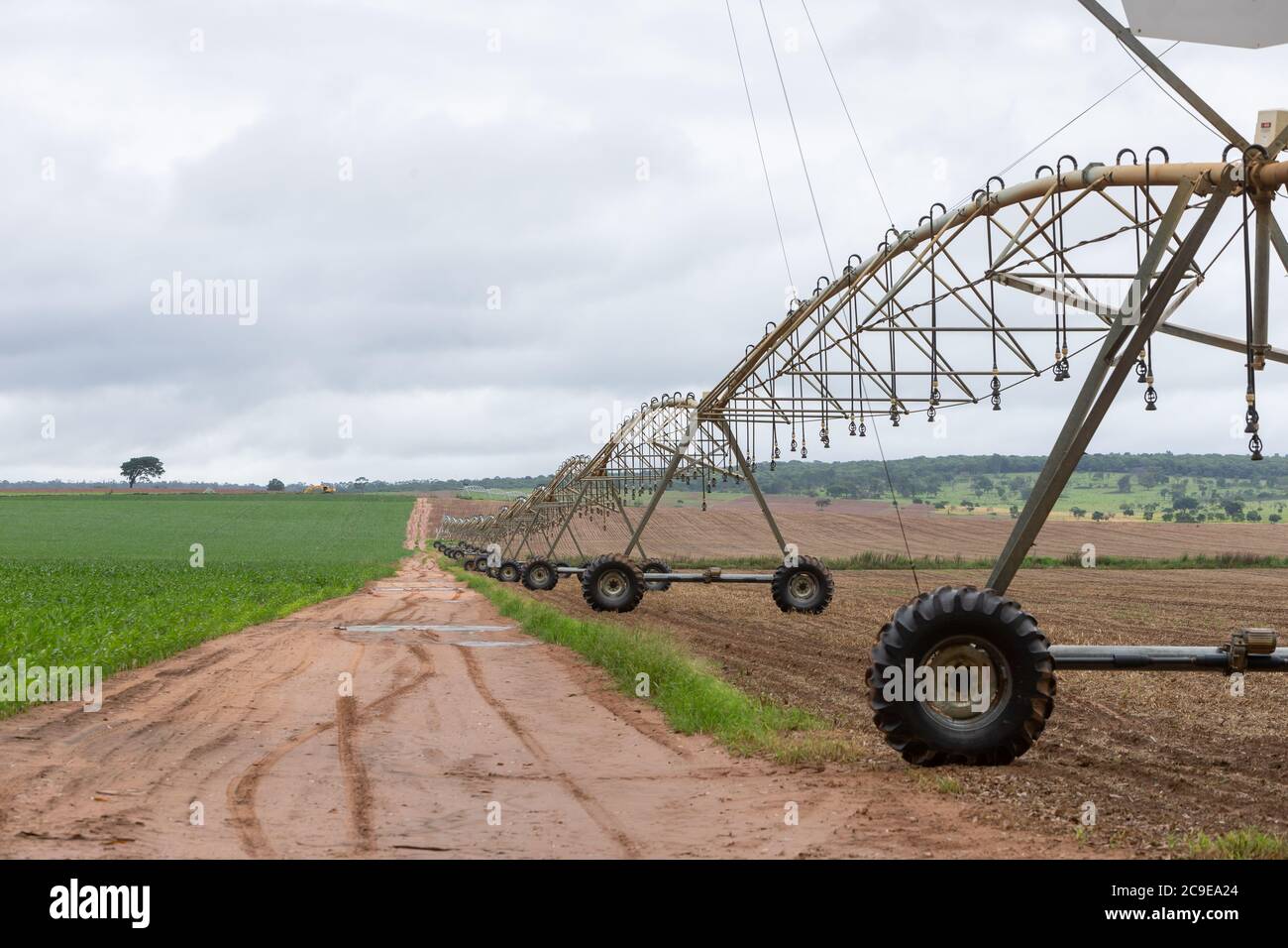 center pivot agricultural irrigation system watering on a farm field ...