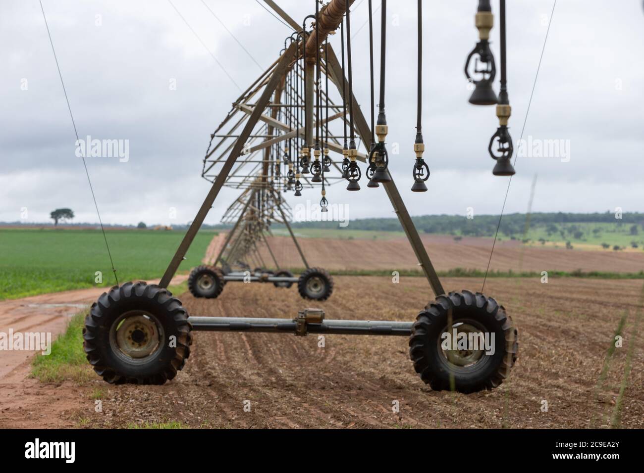 center pivot agricultural irrigation system watering on a farm field ...