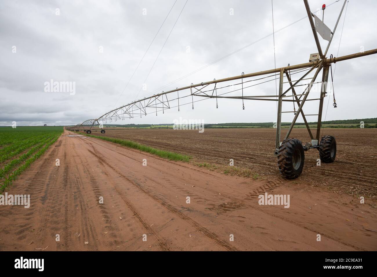 center pivot agricultural irrigation system watering on a farm field ...