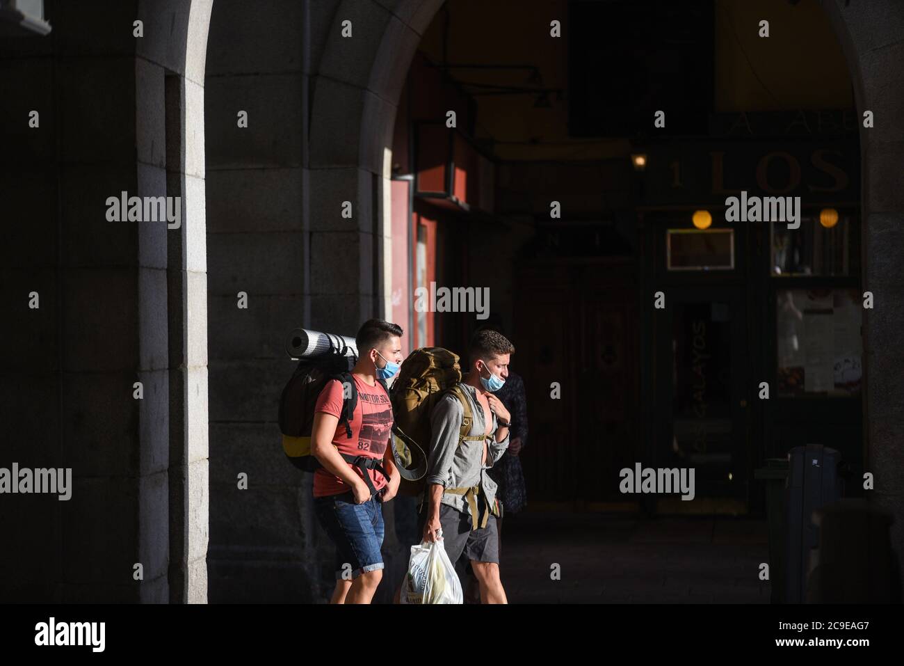 Madrid, Spain. 30th July, 2020. People walk along the street while ...