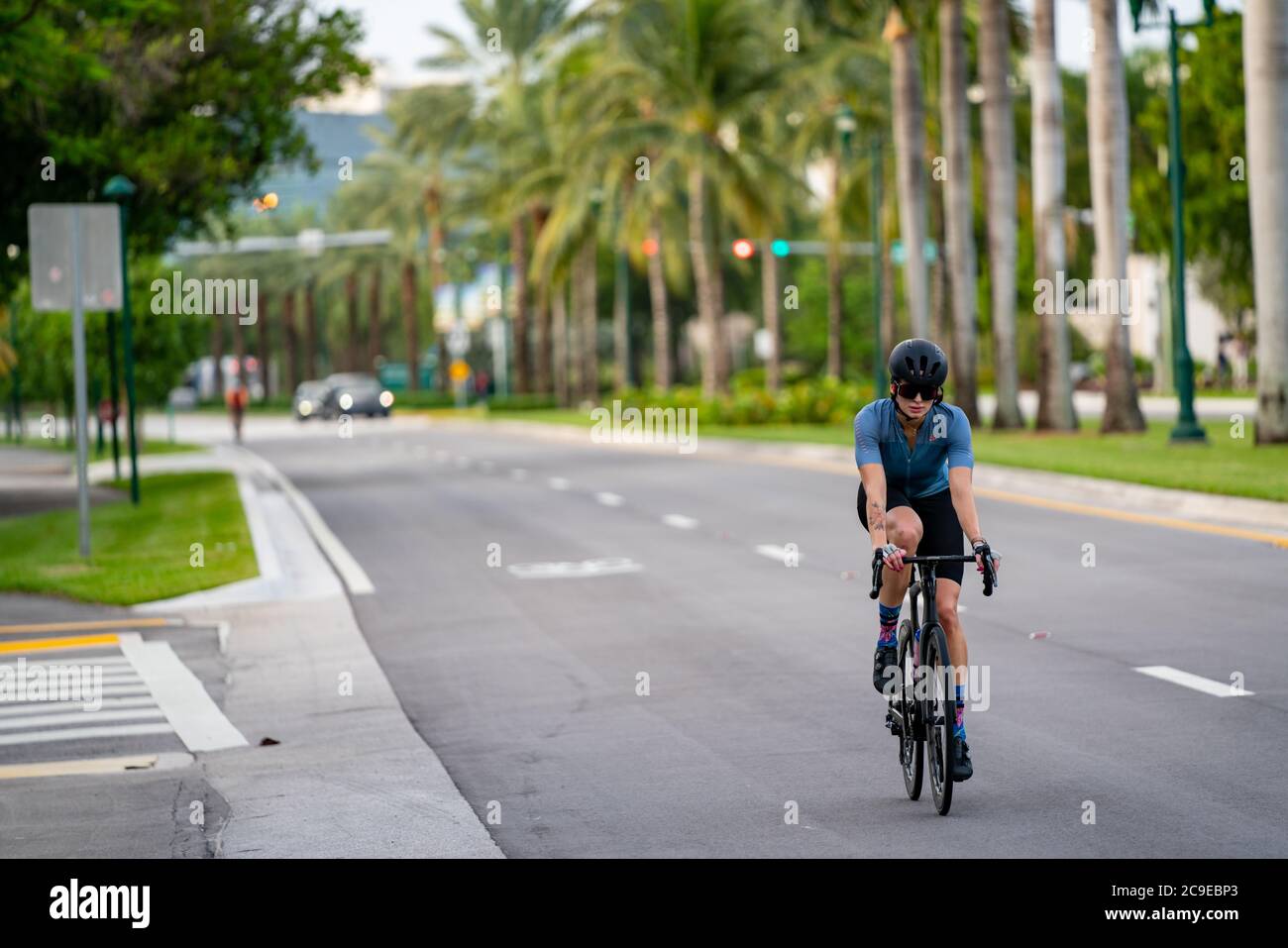 Photo of a beautiful woman riding a racing bike Stock Photo - Alamy