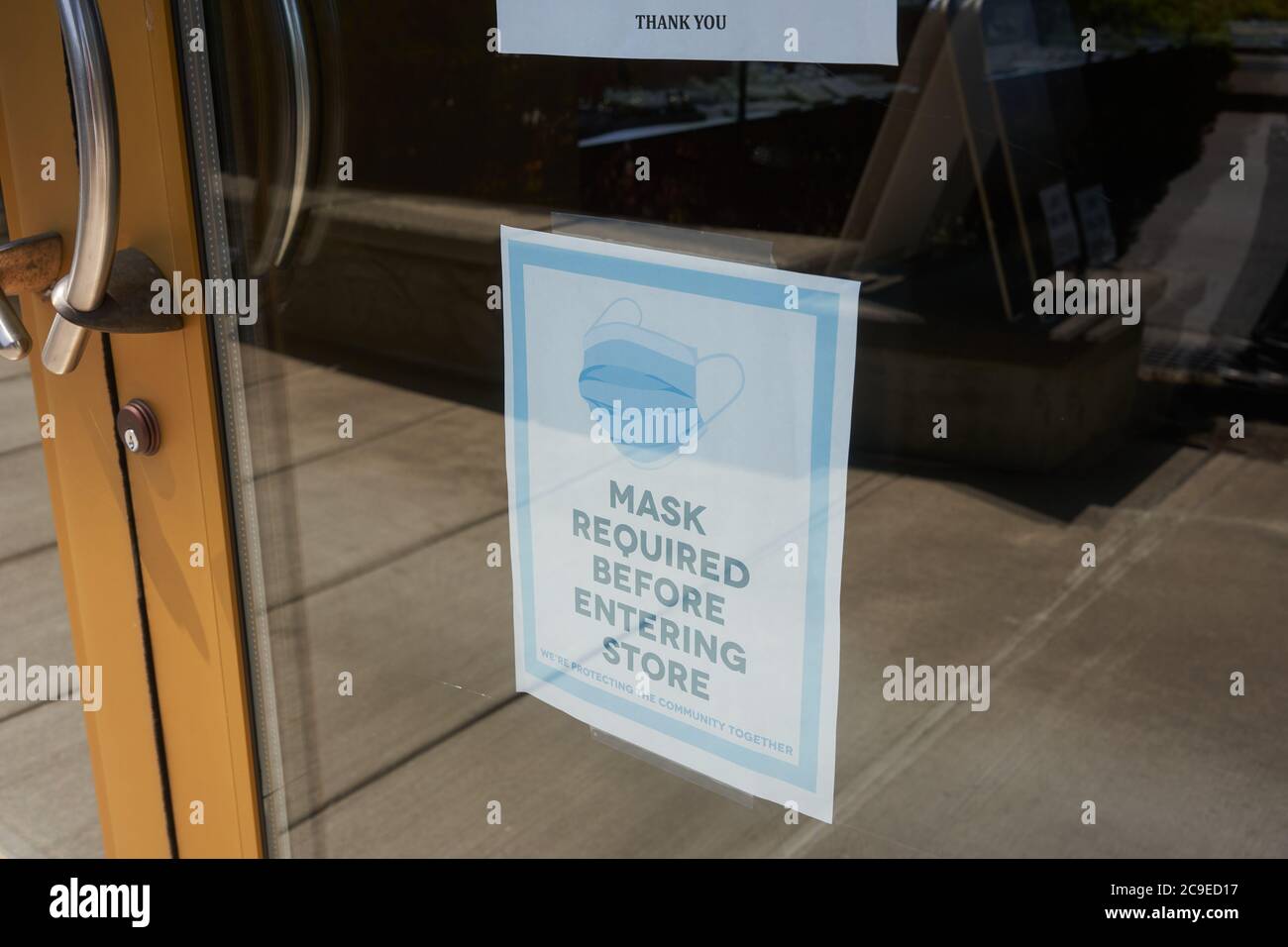 Mandatory mask policy signage at the entrance to a retail store during ...