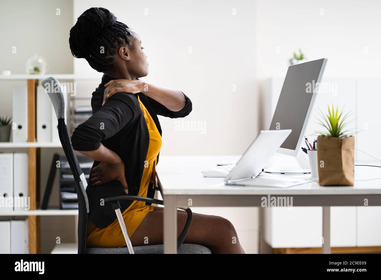 Back Pain Bad Posture Woman Sitting In Office Stock Photo - Alamy
