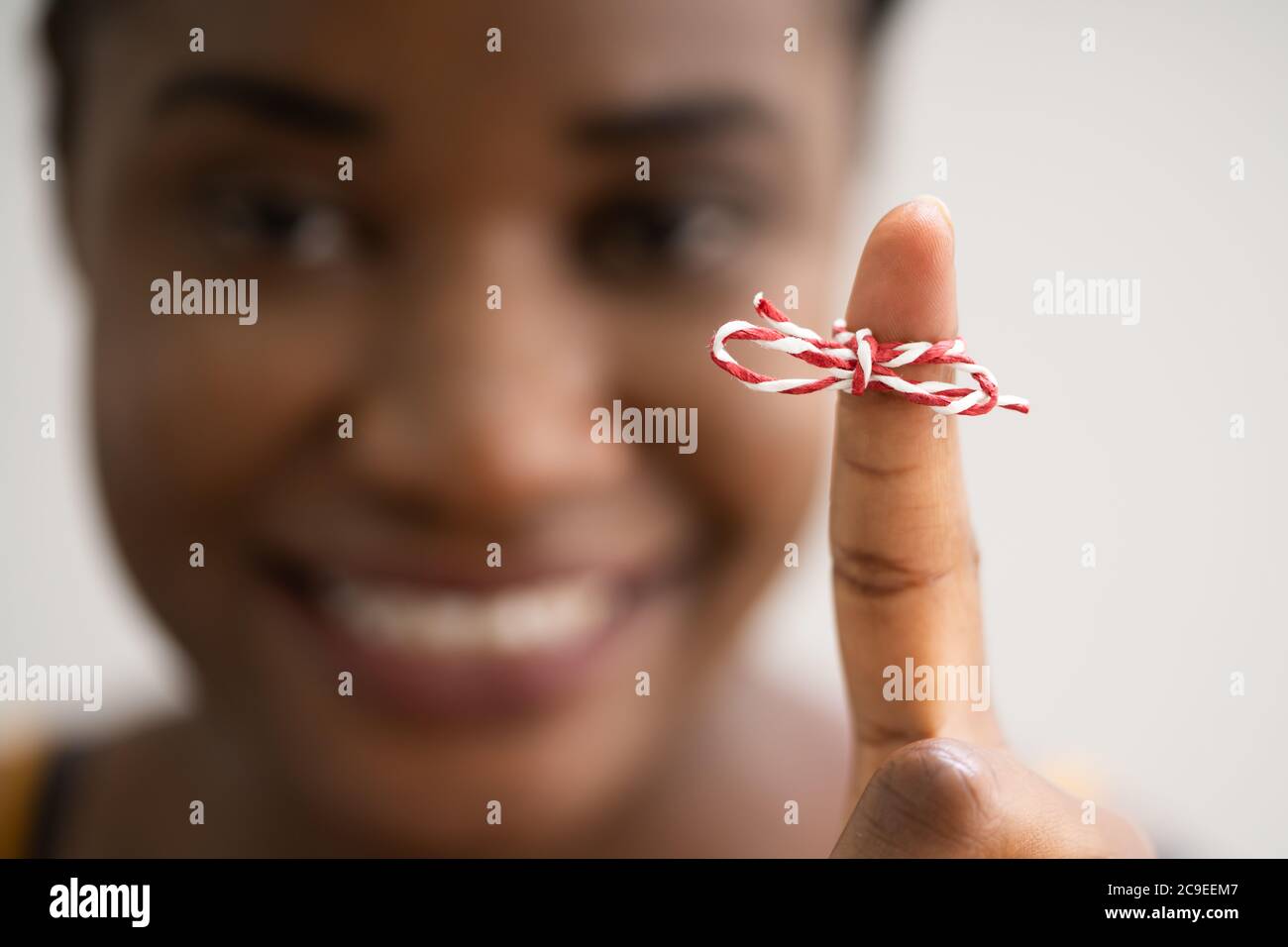 African American Woman With Memory Ribbon On Finger Stock Photo - Alamy