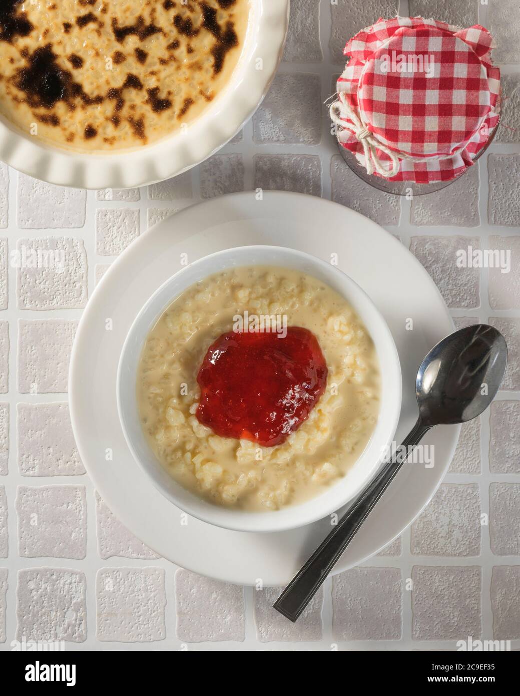 Rice pudding with jam. Traditional dessert UK Stock Photo - Alamy