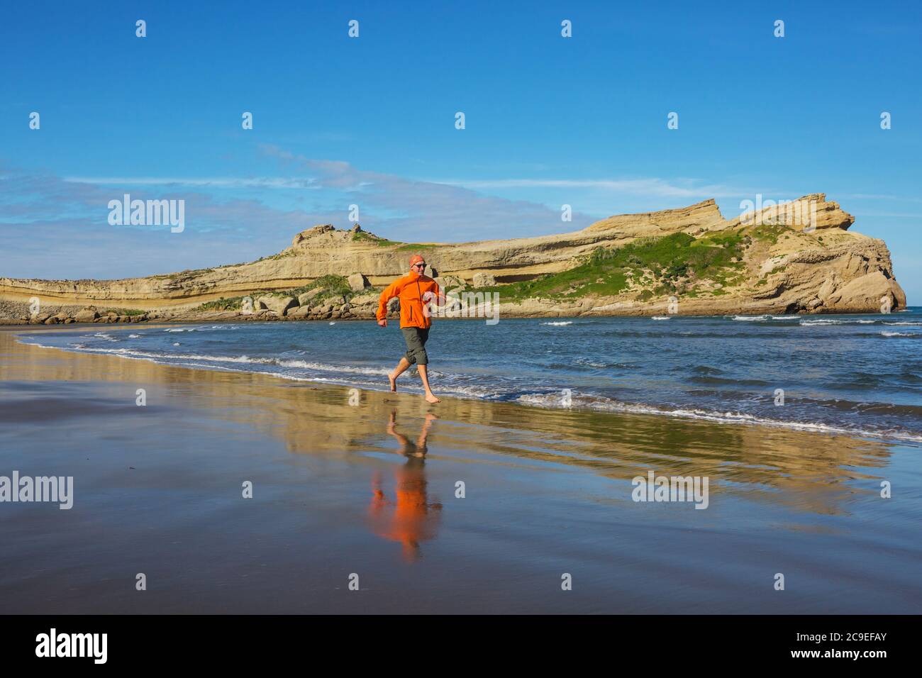 Running man in ocean coast, New Zealand Stock Photo - Alamy