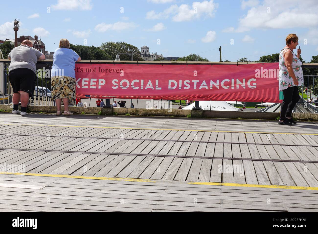 People keeping their distance on Southport pier Stock Photo - Alamy