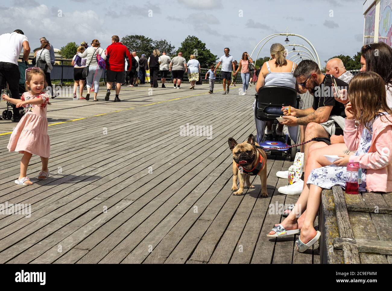 Girl dancing for her family on seaside day out Stock Photo - Alamy