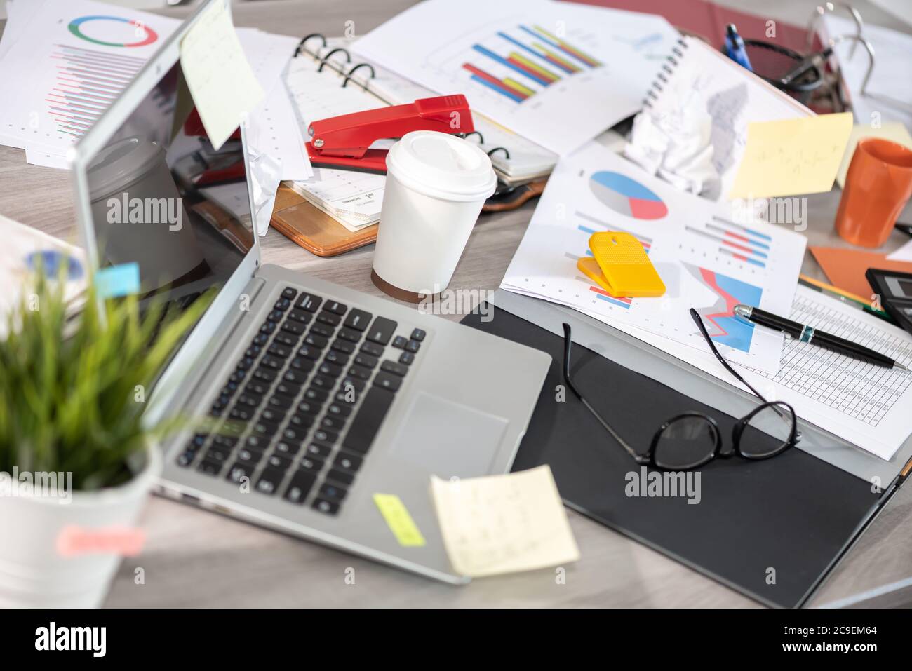 Messy and cluttered office desk Stock Photo - Alamy