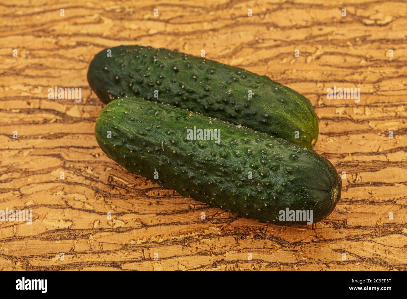 Green fresh two cucumbers over background Stock Photo - Alamy