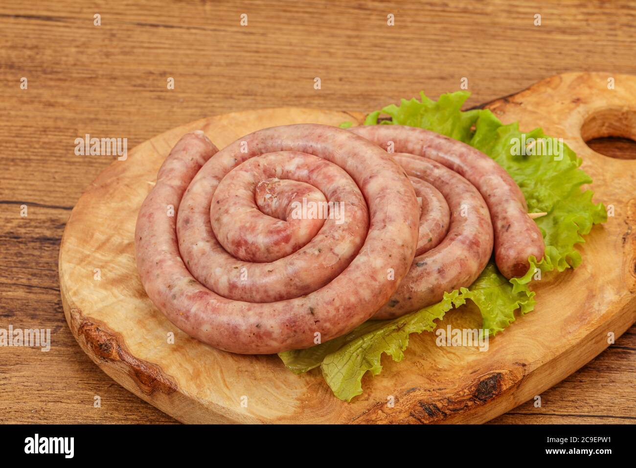 Raw pork sausage ring for grill Stock Photo - Alamy