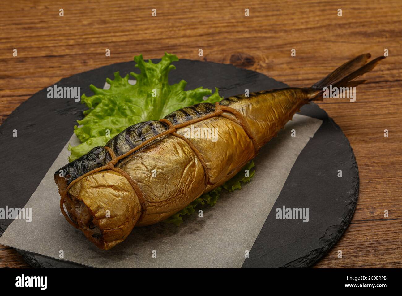 Smoked tasty mackerel fish snack over board Stock Photo - Alamy