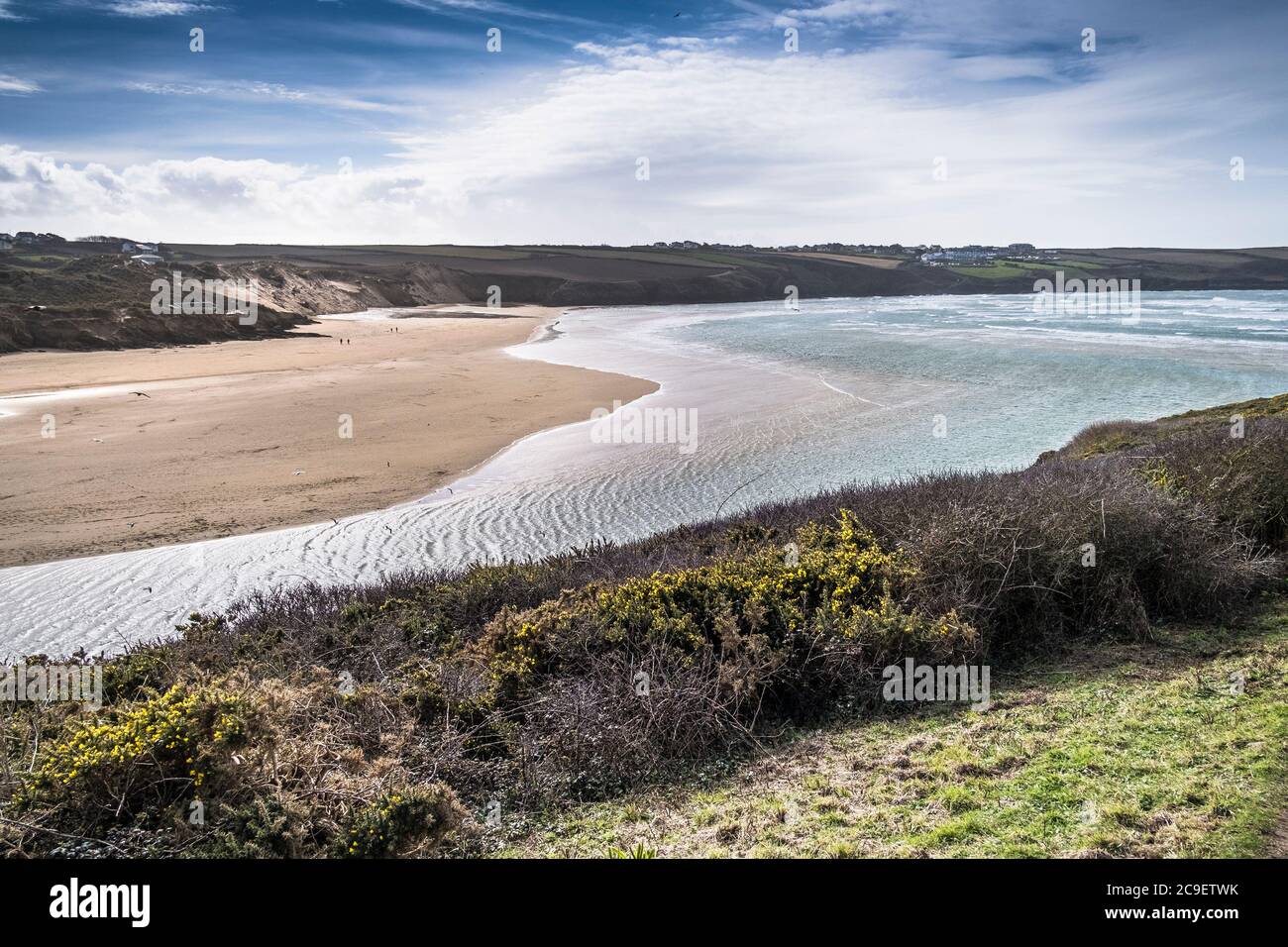 A view over the incoming tide as it flows onto Crantock Beach and along ...