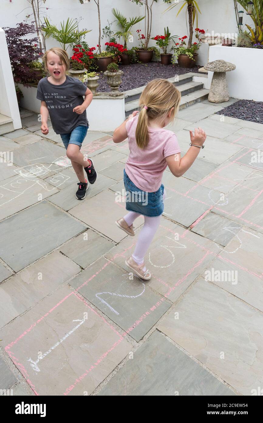 Children playing the tradional game of hopscotch Stock Photo - Alamy