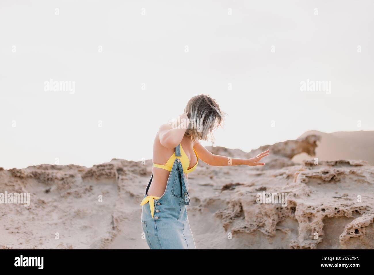 Woman in the beach wearing yellow swimsuit Stock Photo - Alamy
