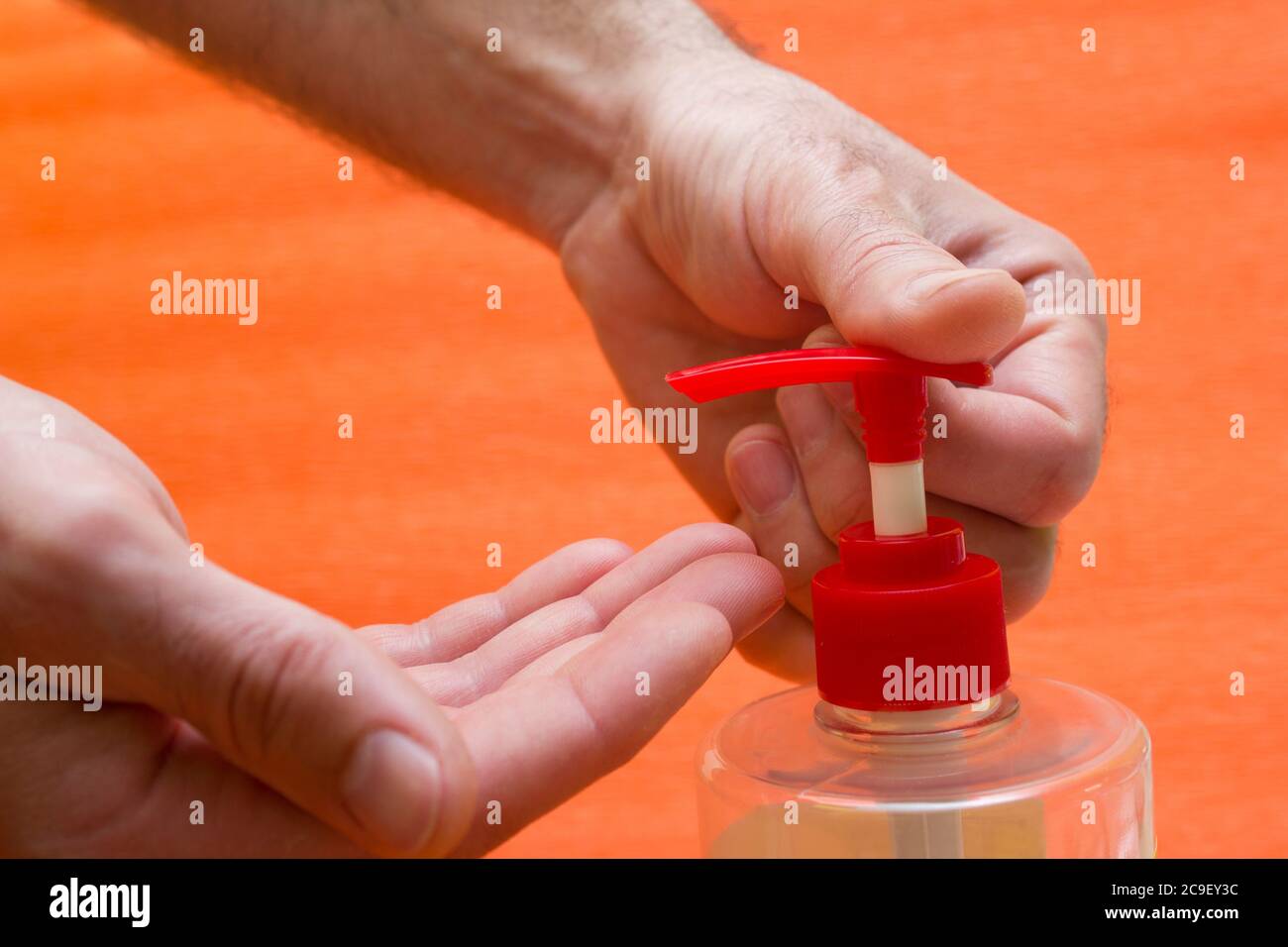 Men's hands with a liquid soap dispenser, alcohol-based antiseptics ...