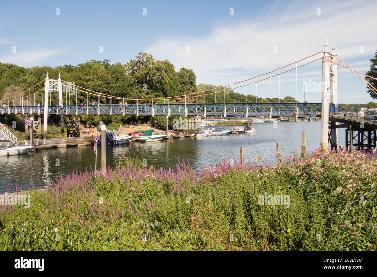 A summer day on Teddington Lock Footbridge on the River Thames ...