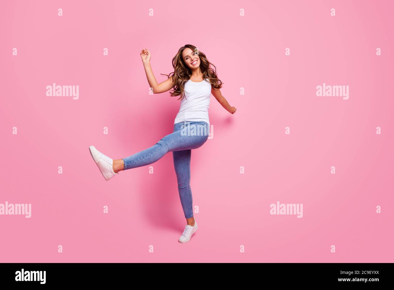 Full body photo of crazy excited lady good mood raise leg hands walking ...