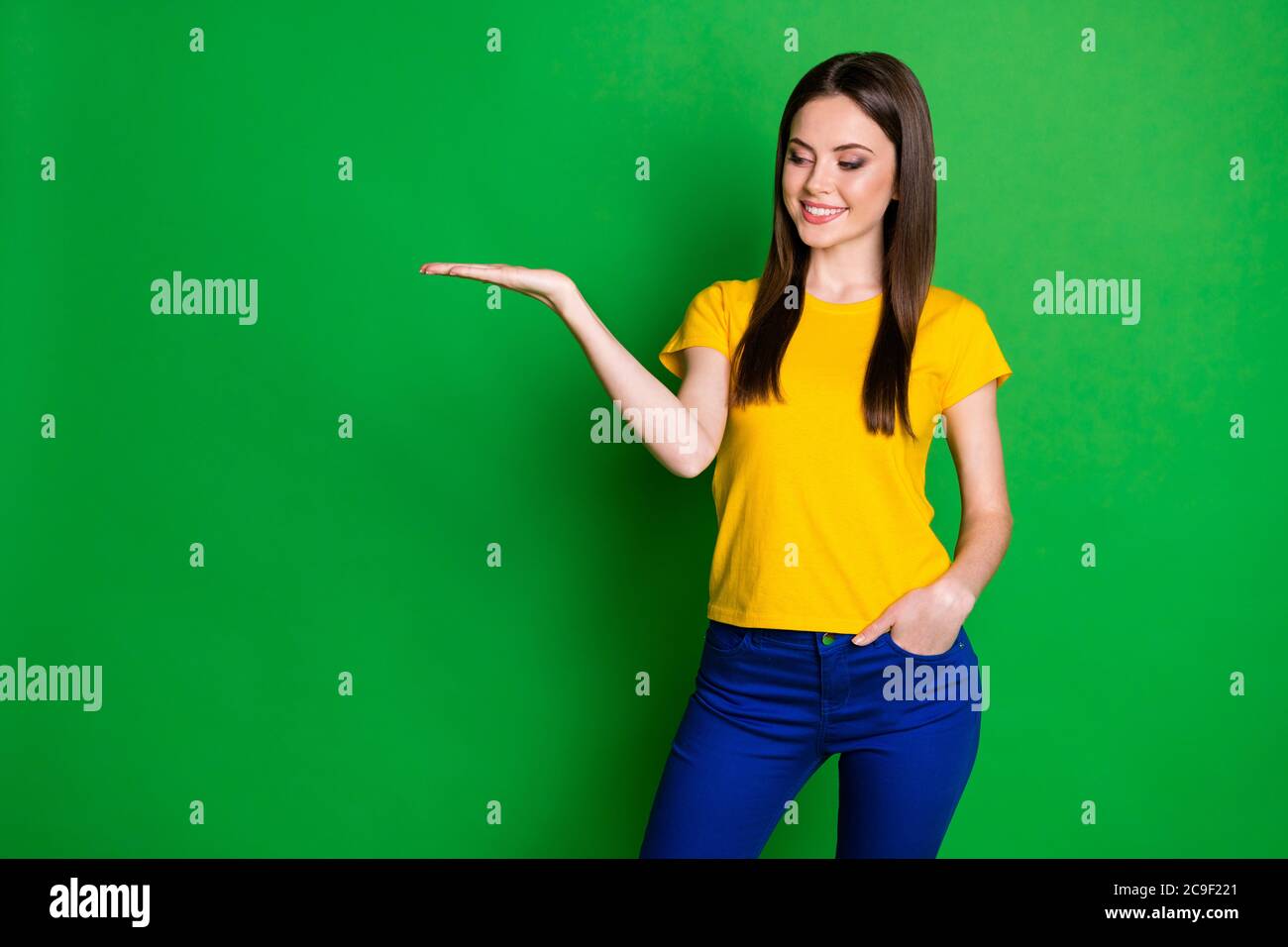 Portrait of positive cheerful girl promoter hold hand advertise promo ...