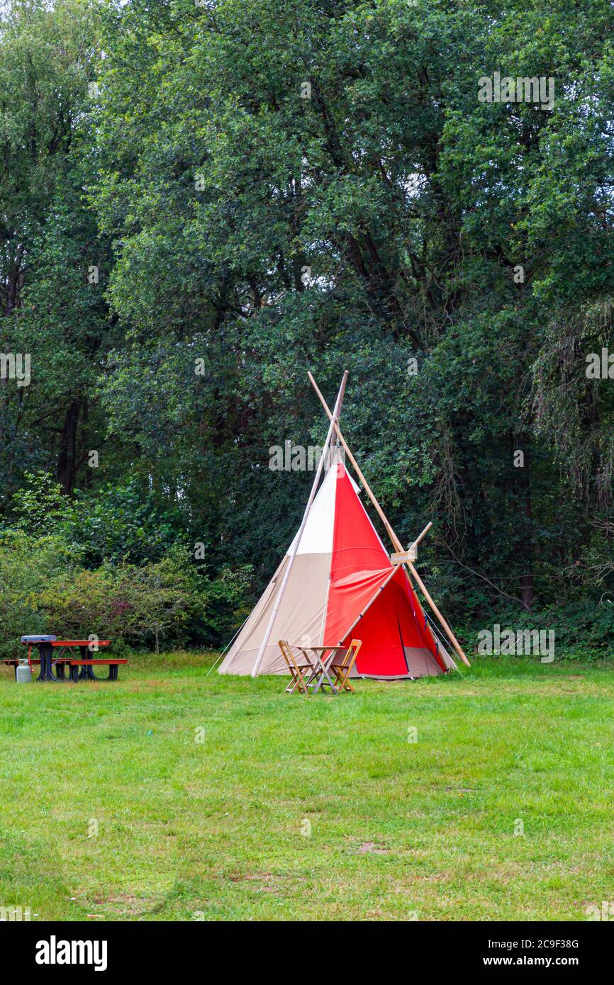Colorful campsite with teepee or wigwam tents in green area Stock Photo ...