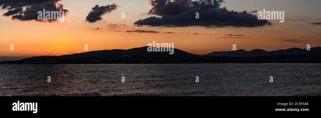 Panorama of a colorful sea sunset. Cloudy and dark summer landscape ...