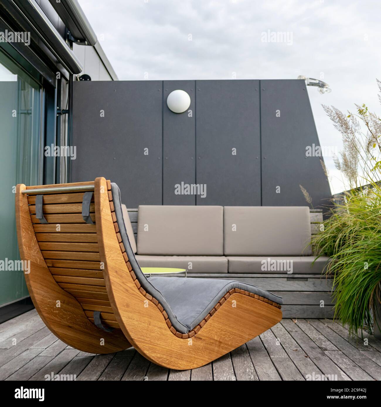 Rocking lounger on a roof terrace with bamboo and grasses Stock Photo ...