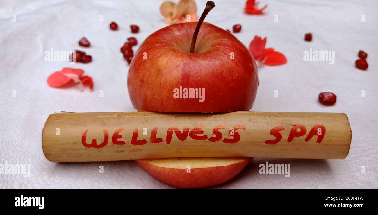 Wellness spa word presented on bamboo stick with colorful flowers and ...